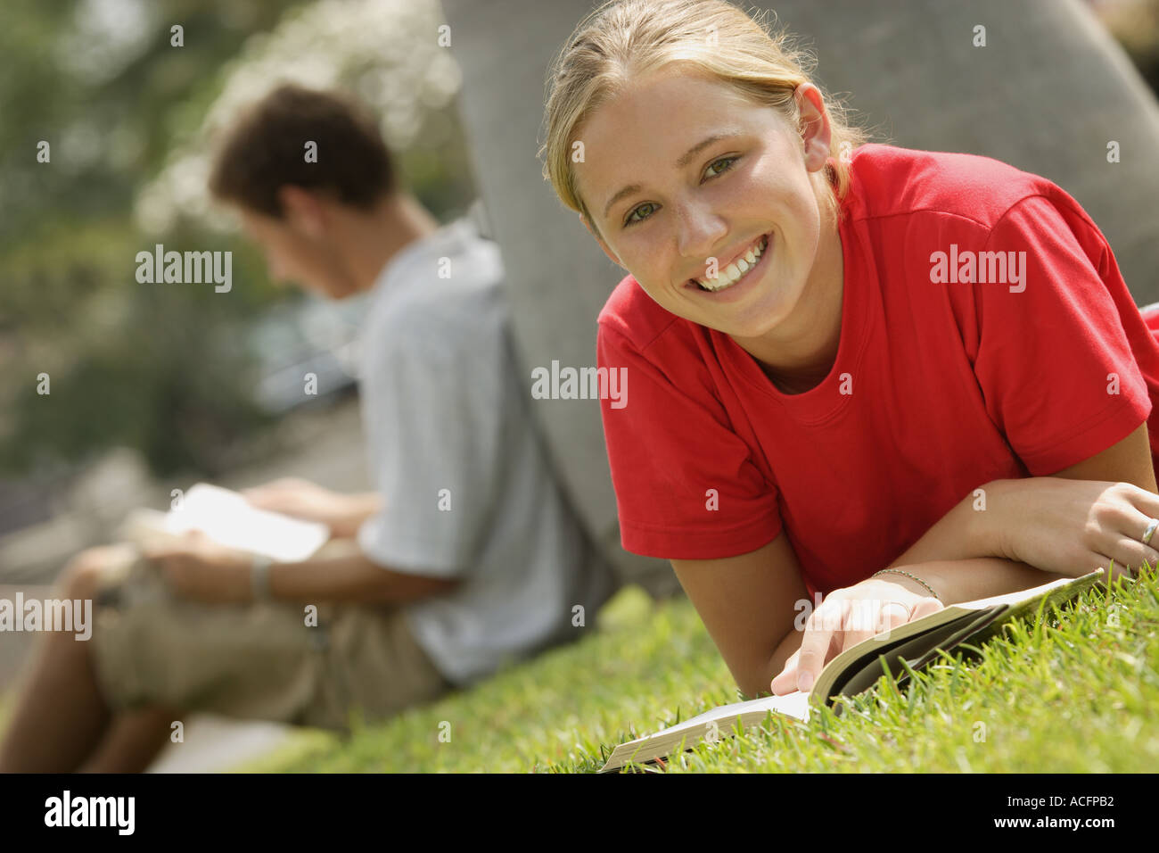 Blonde student reading outside Stock Photo - Alamy