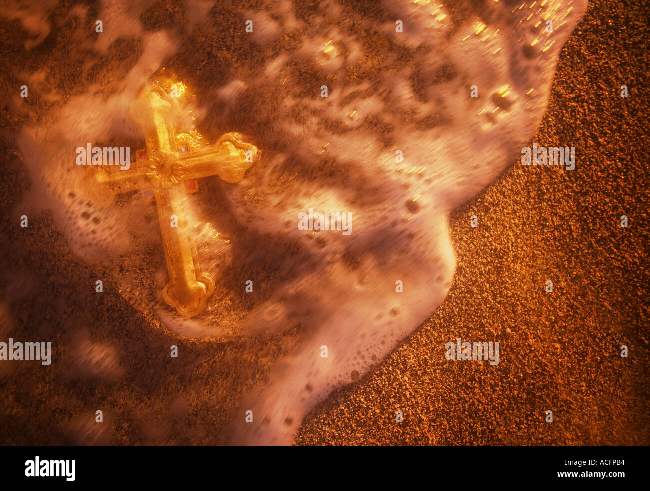 Cross being washed over by wave on sandy beach Stock Photo - Alamy