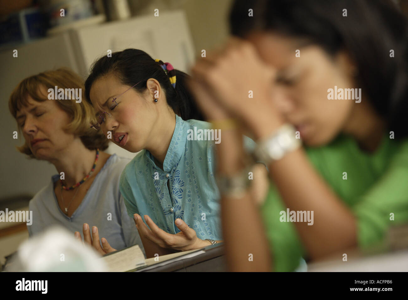People praying in a classroom Stock Photo - Alamy