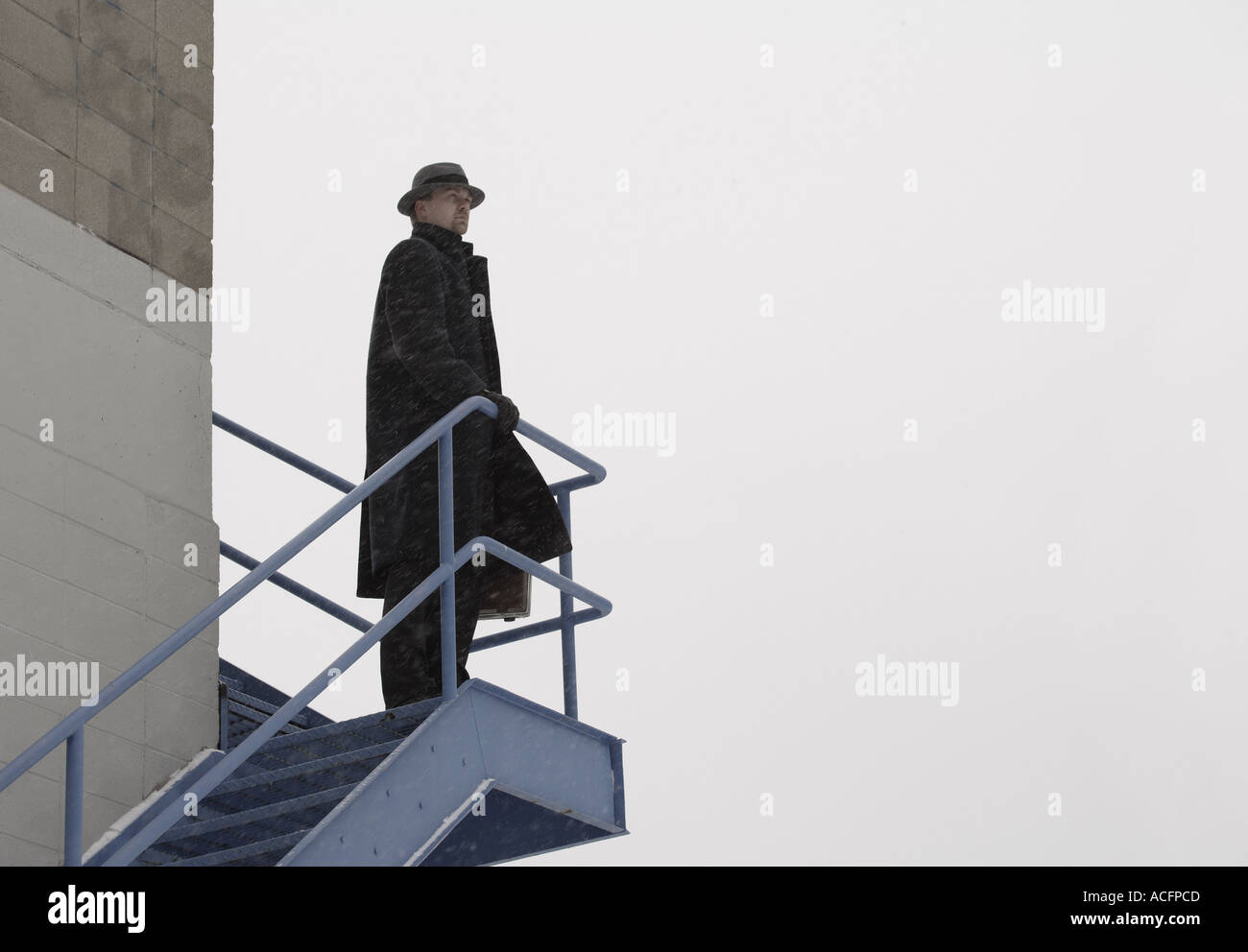 Lone man standing on an outdoor staircase Stock Photo - Alamy
