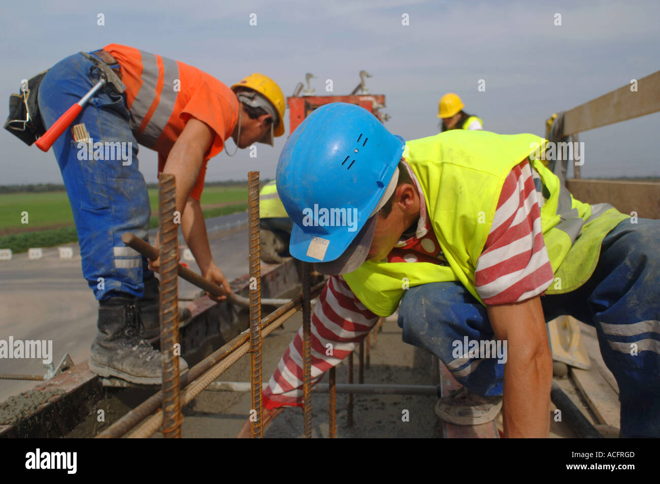 Laying road - workers constructing a bridge on the M5 toll motorway in ...