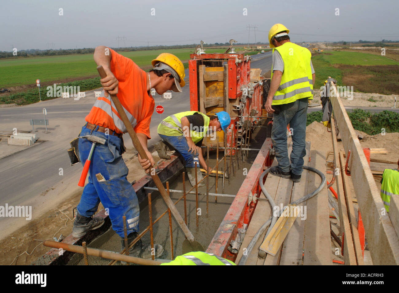 Laying road - workers constructing a bridge on the M5 toll motorway in ...
