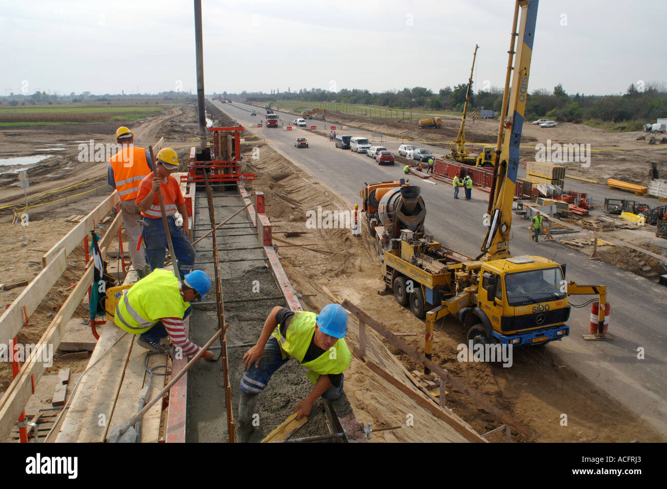 Laying road - workers constructing a bridge on the M5 toll motorway in ...