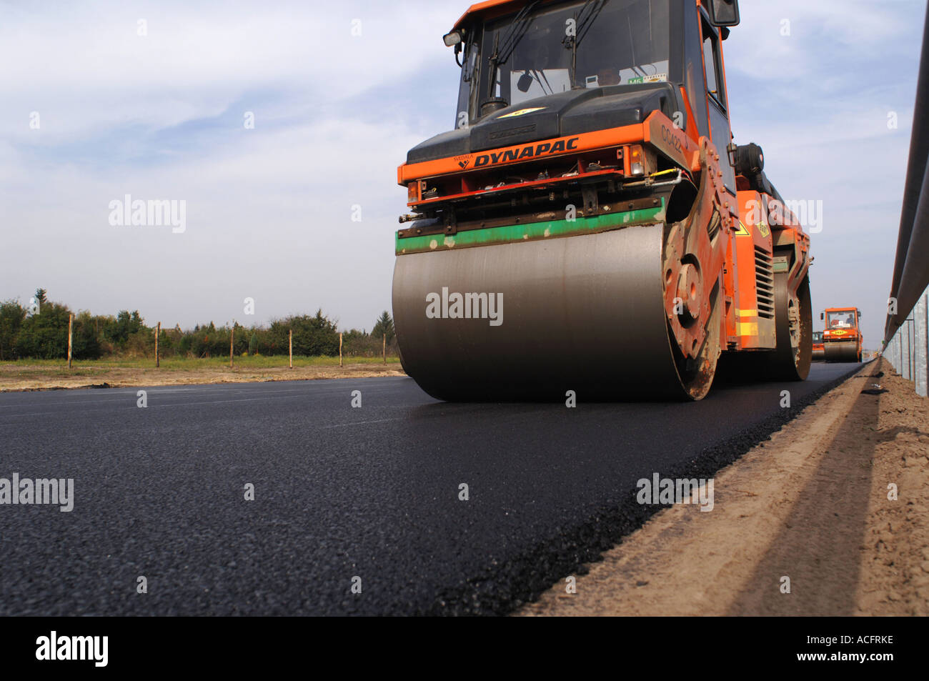Laying road - flattening tarmac with steamrollers on the M5 toll ...