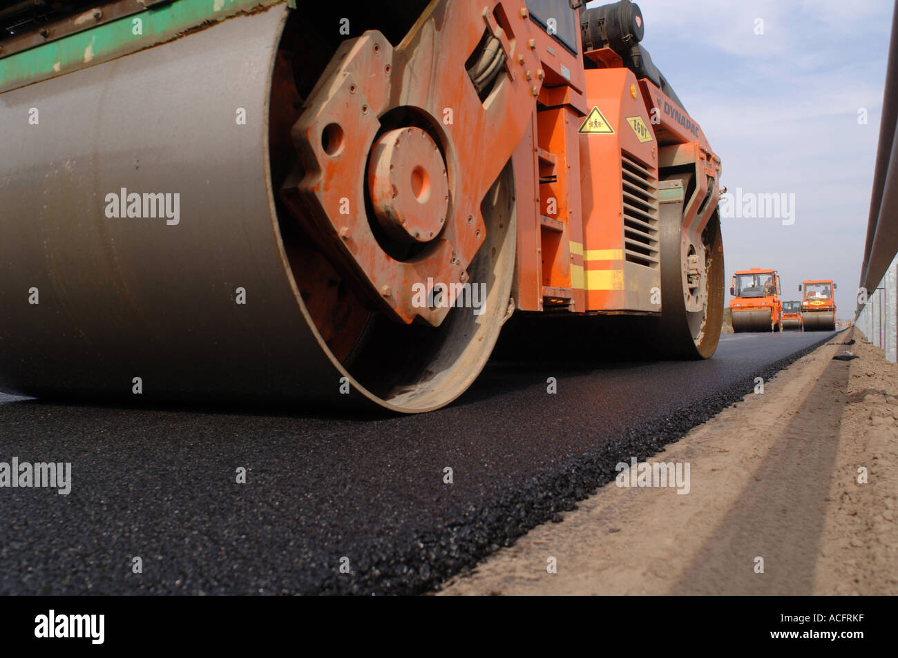 Laying road - flattening tarmac with steamrollers on the M5 toll ...