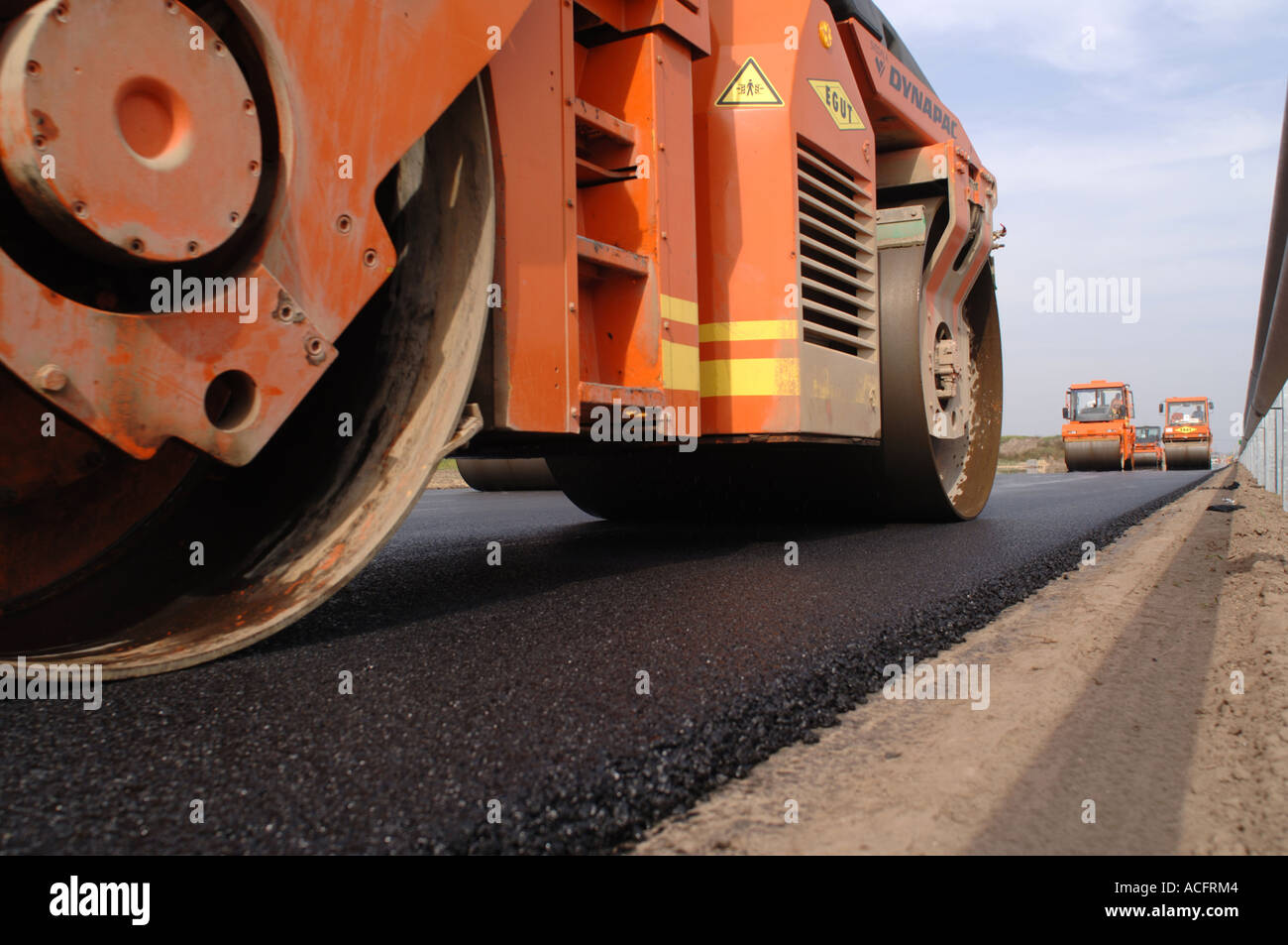 Laying road - flattening tarmac with steamrollers on the M5 toll ...