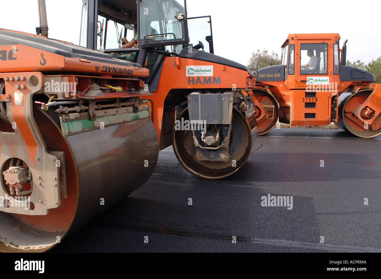 Laying road - flattening tarmac with steamrollers on the M5 toll ...