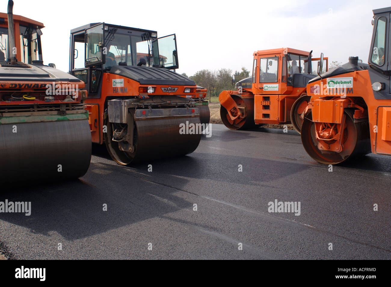 Laying road - flattening tarmac with steamrollers on the M5 toll ...