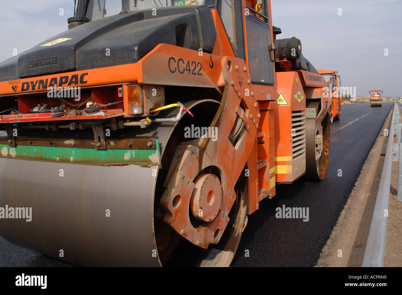 Laying road - flattening tarmac with steamrollers on the M5 toll ...