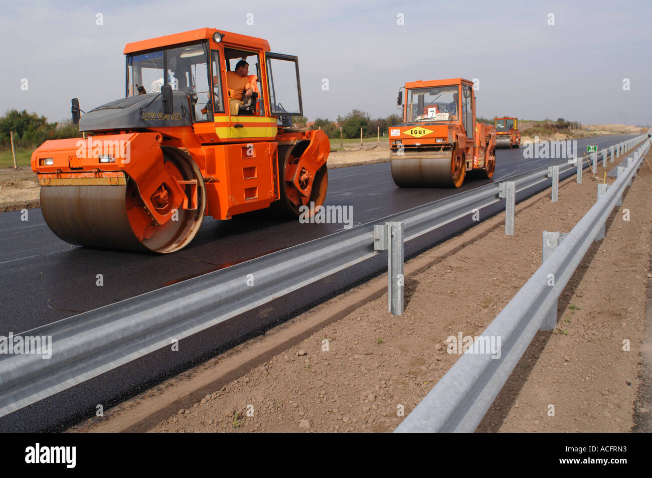 Laying road - flattening tarmac with steamrollers on the M5 toll ...
