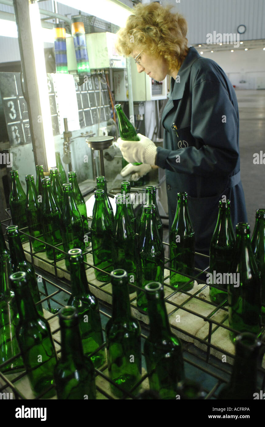 A worker checking bottles during quality control inspection in Gostomel ...
