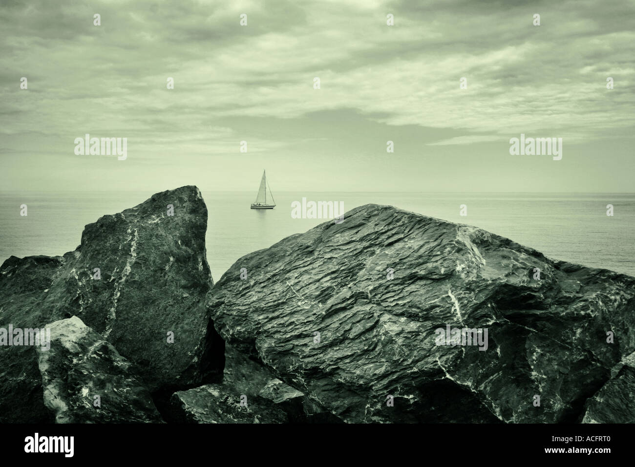 photo of a boat sailing between rocks Stock Photo - Alamy