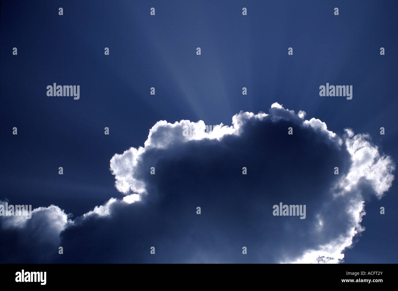 Sunburst and halo surround cloud and clear blue sky Stock Photo - Alamy