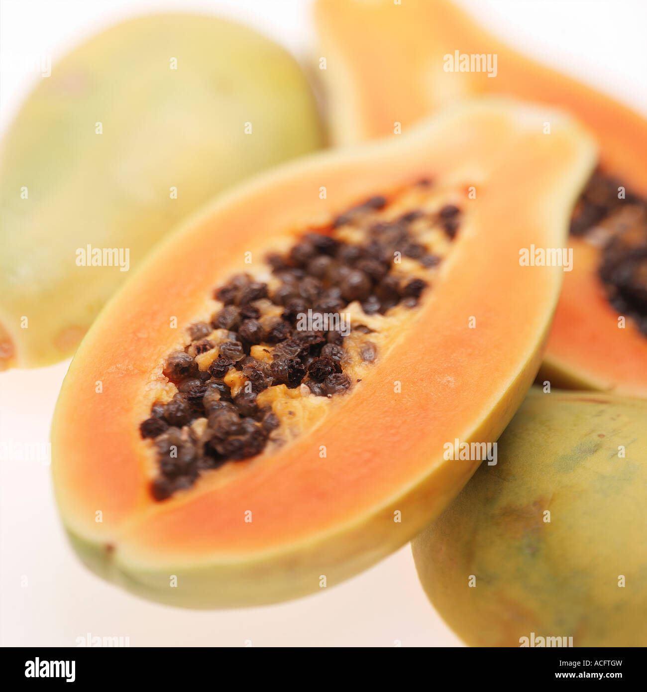 Papaya Fruit cut in half showing the pips Stock Photo - Alamy