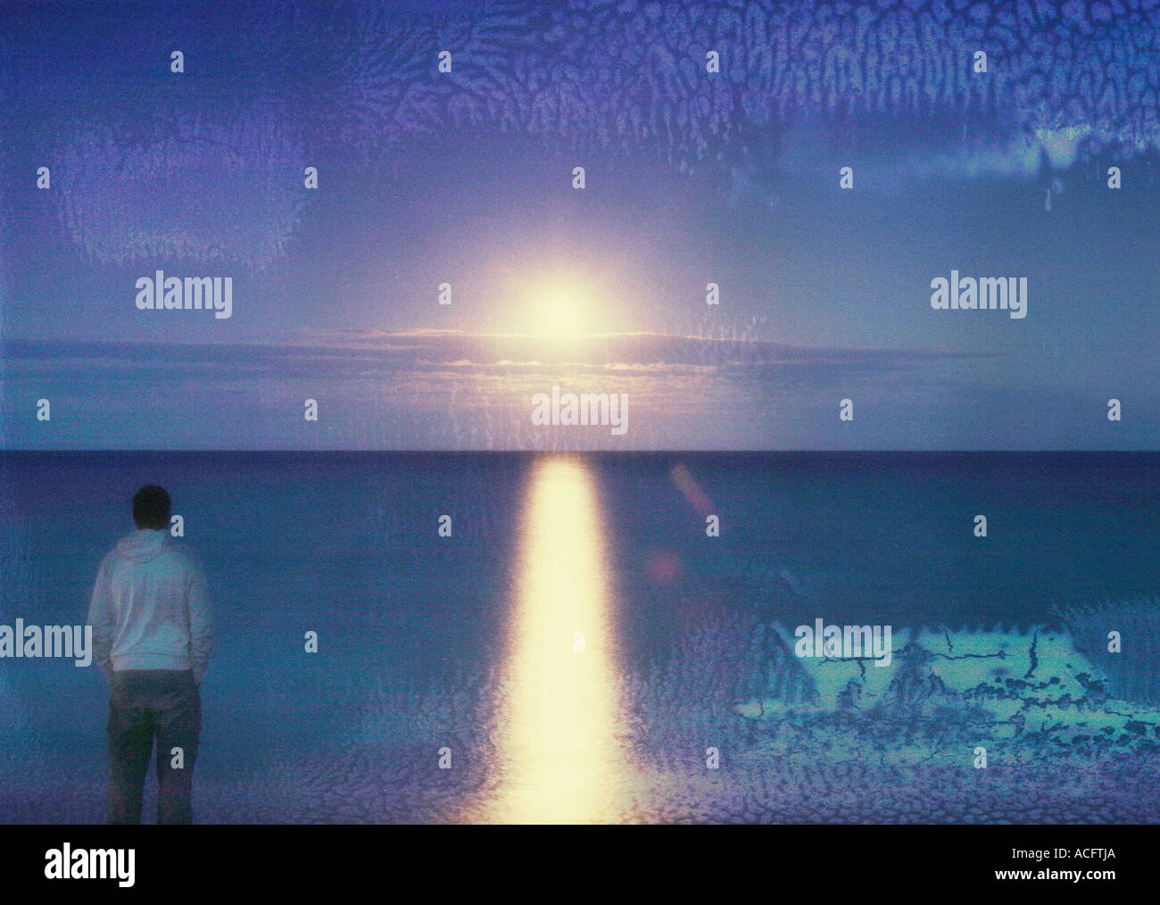 photo of a man looking at a full moon Stock Photo - Alamy