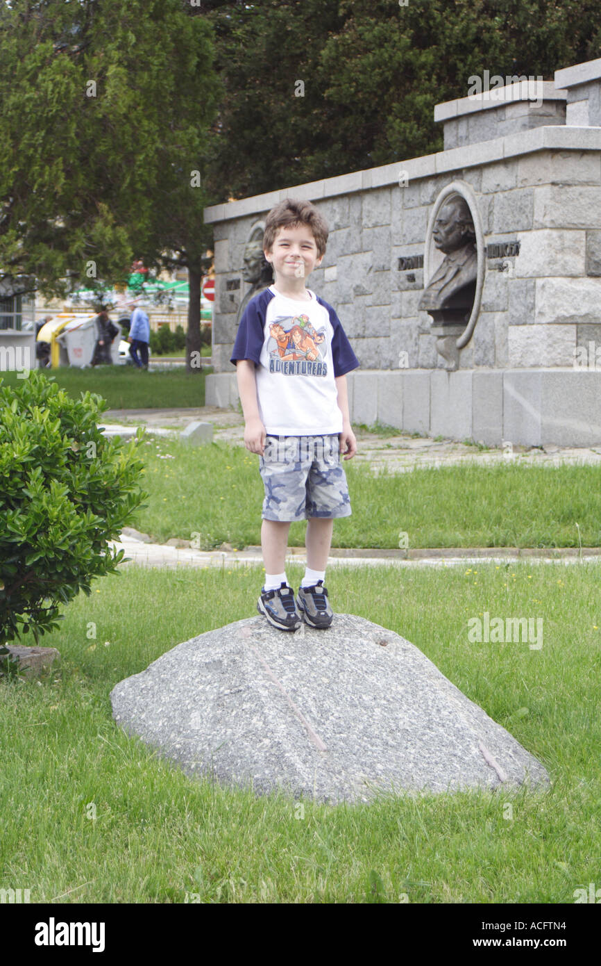 Boy on a big stone Stock Photo - Alamy