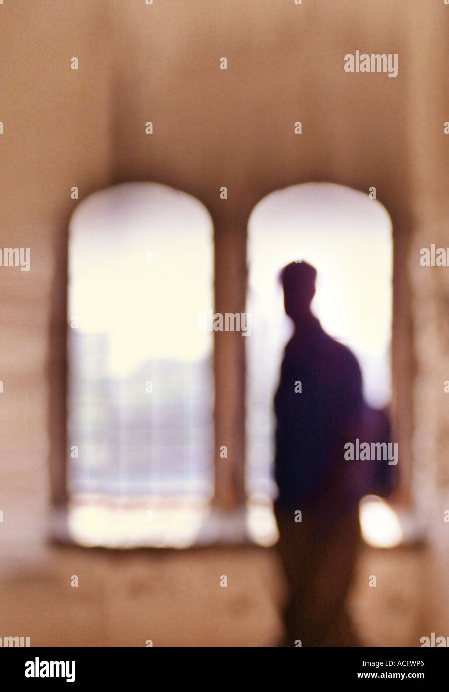 Photo of a silhouetted figure infront of a window Stock Photo - Alamy