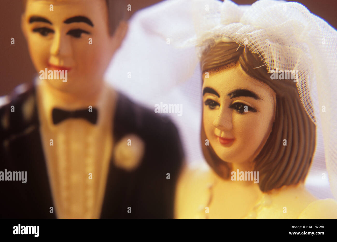 Close up in warm golden light of a plastic miniature model of a man and ...