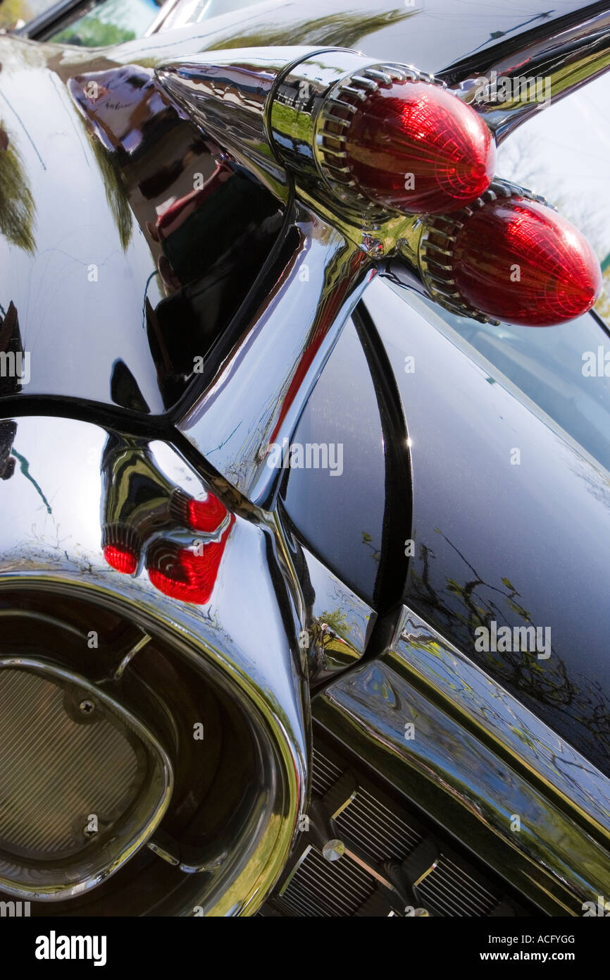 Chrome fins and tail lights at the back of a black 1959 Cadillac Coupe ...