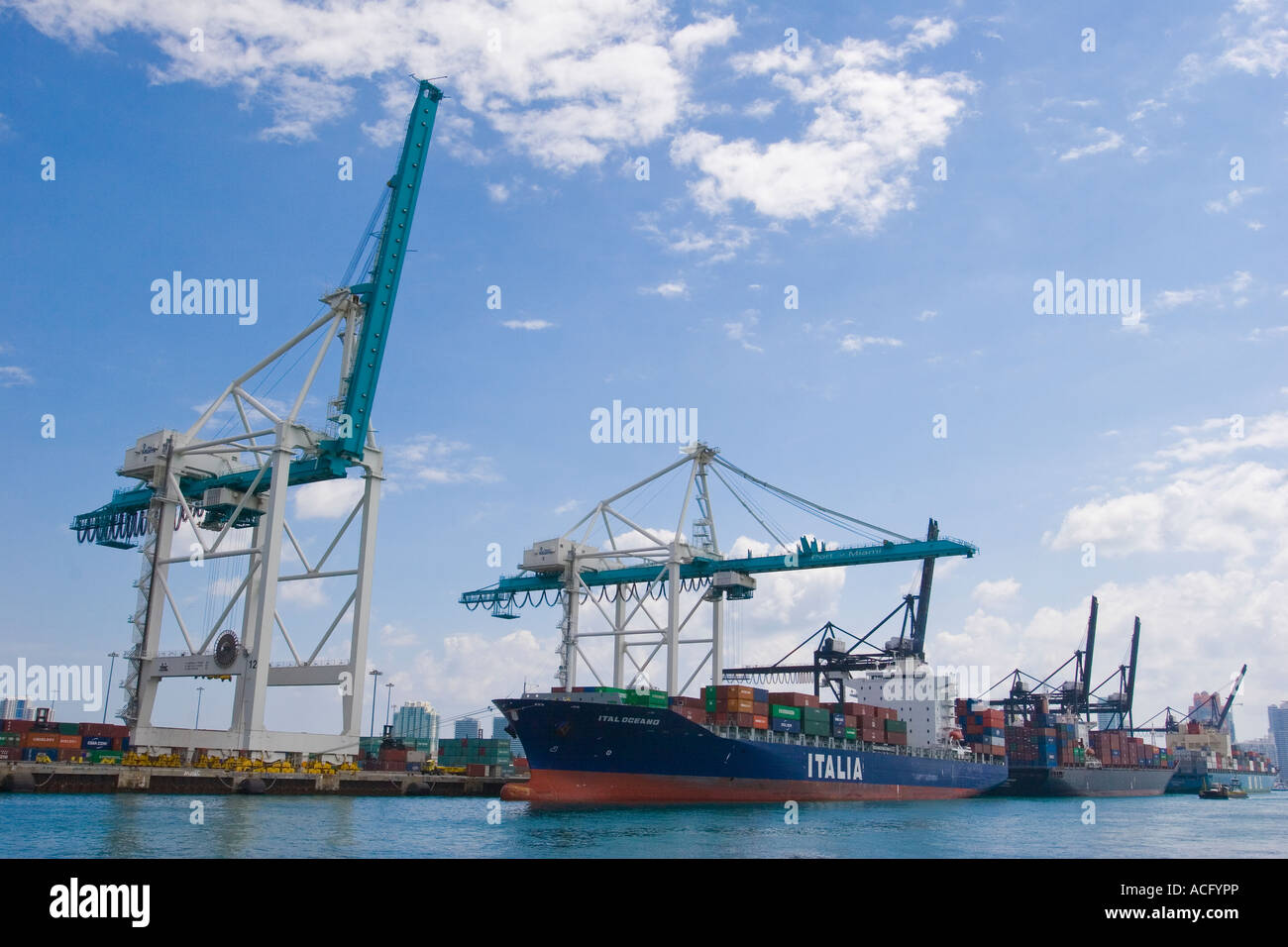 Three container ships loaded with cargo docked at Port of Miami beside ...