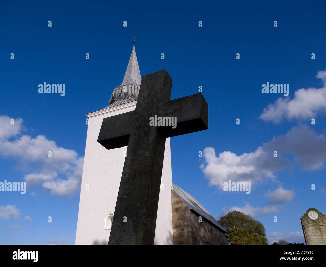 Stone cross in front of church tower as a symbol of every thing to du ...