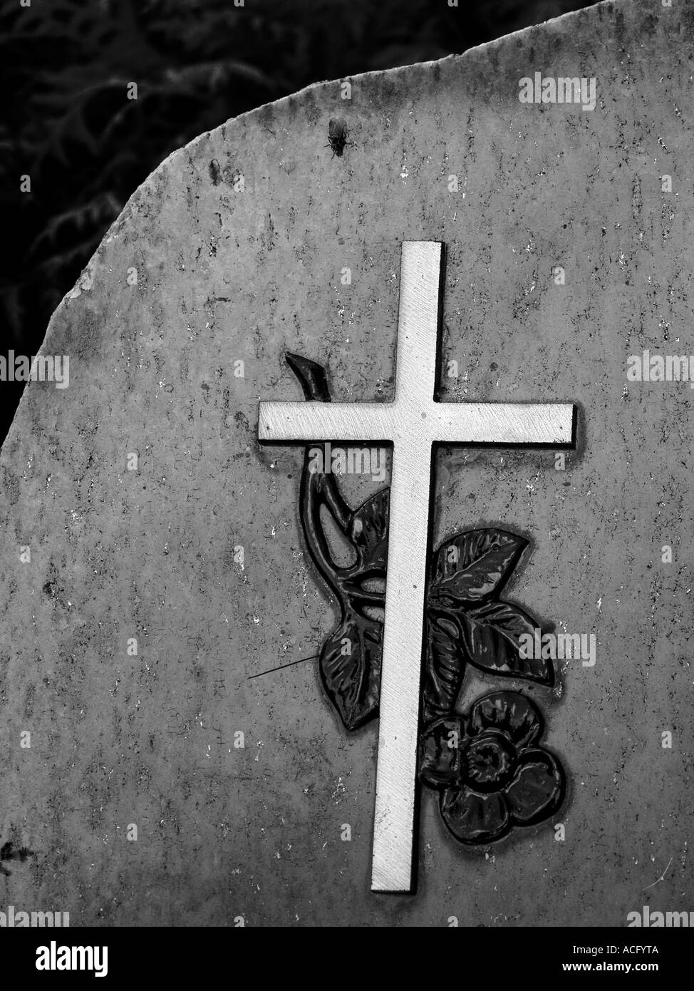 A simple cross an a gravestone as symbol of life death and religion ...