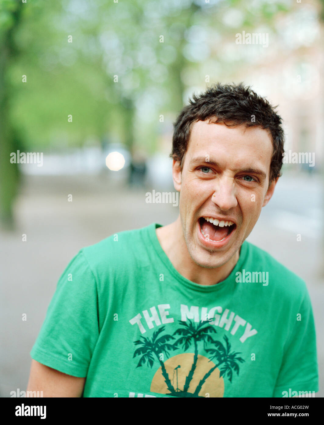 A man with a mischievous facial expression portrait Stock Photo - Alamy