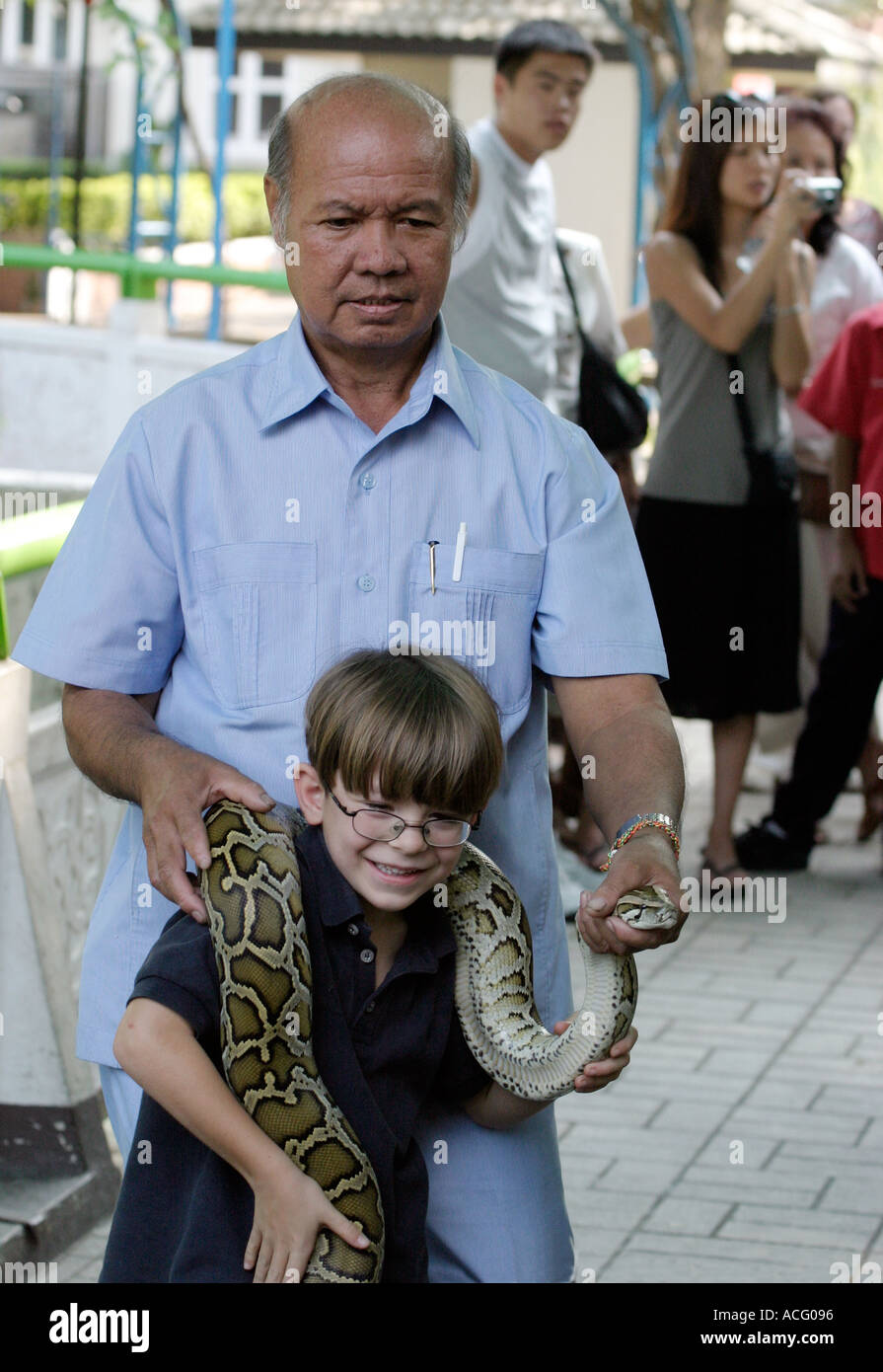 Handler, Python and young boy at Snake Farm. Bangkok, Thailand Stock ...