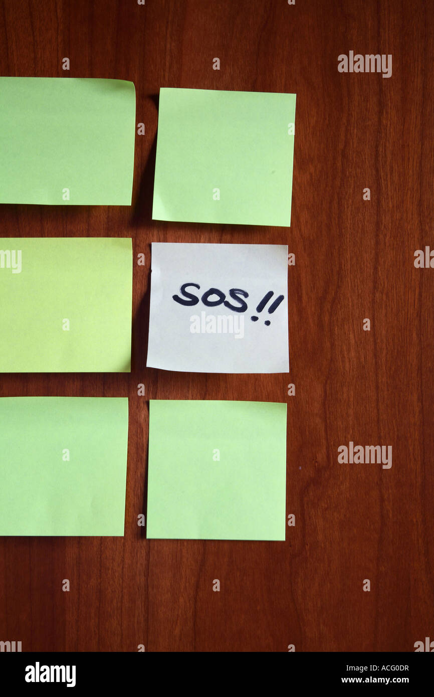 sos ! written on post it note memo Stock Photo - Alamy