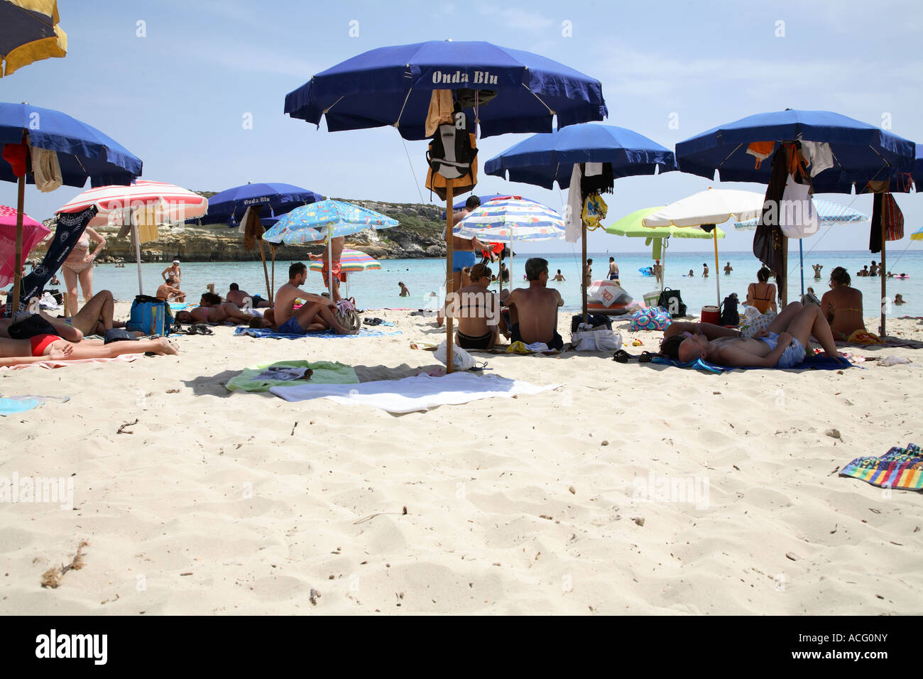 people at the beach during the summer season at the seaside in Italy ...