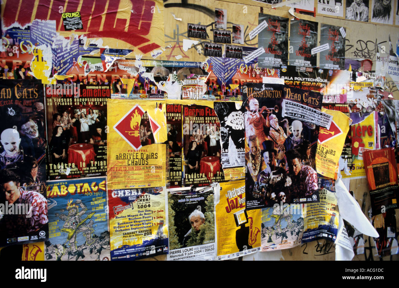 A wall covered with multi colored scraps and bits of torn paper ...