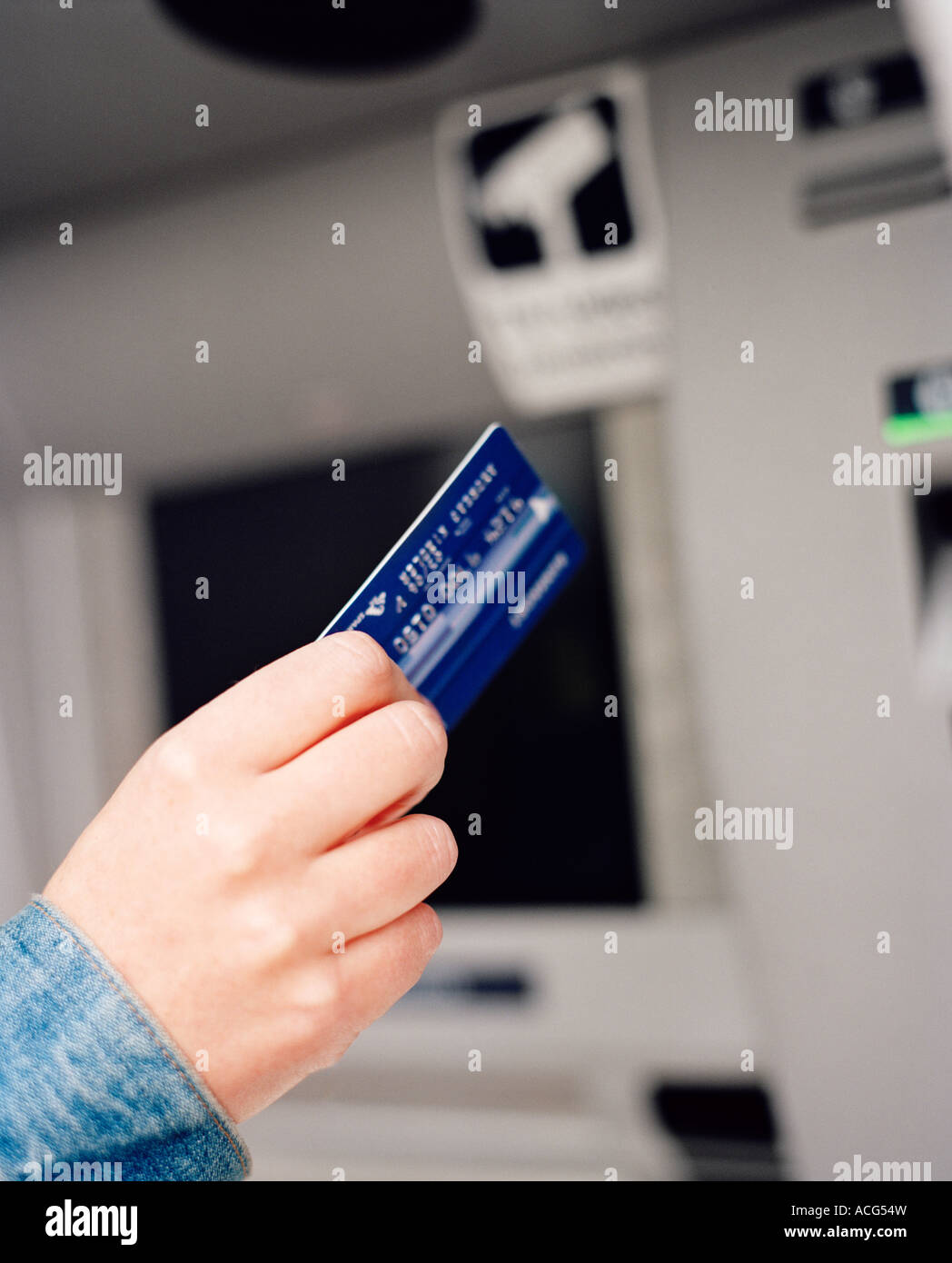A card and a cash-dispenser Stock Photo - Alamy