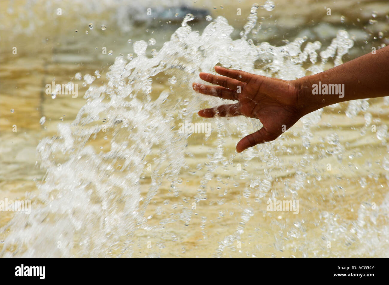 Closeup adult womans hand in water spray from fountain Stock Photo - Alamy