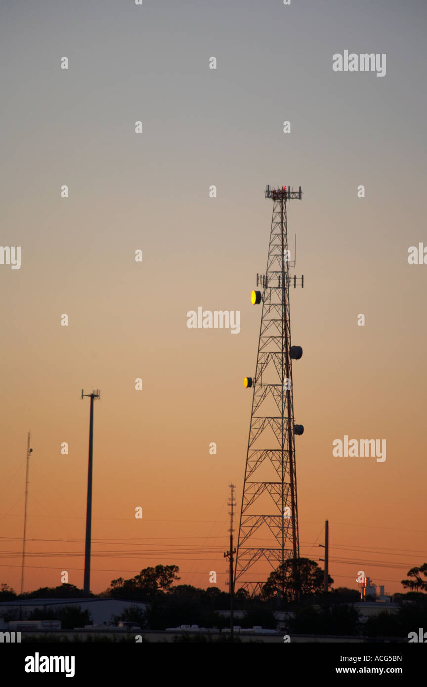 Communications towers in southwestern Florida aganist a sunset sky ...