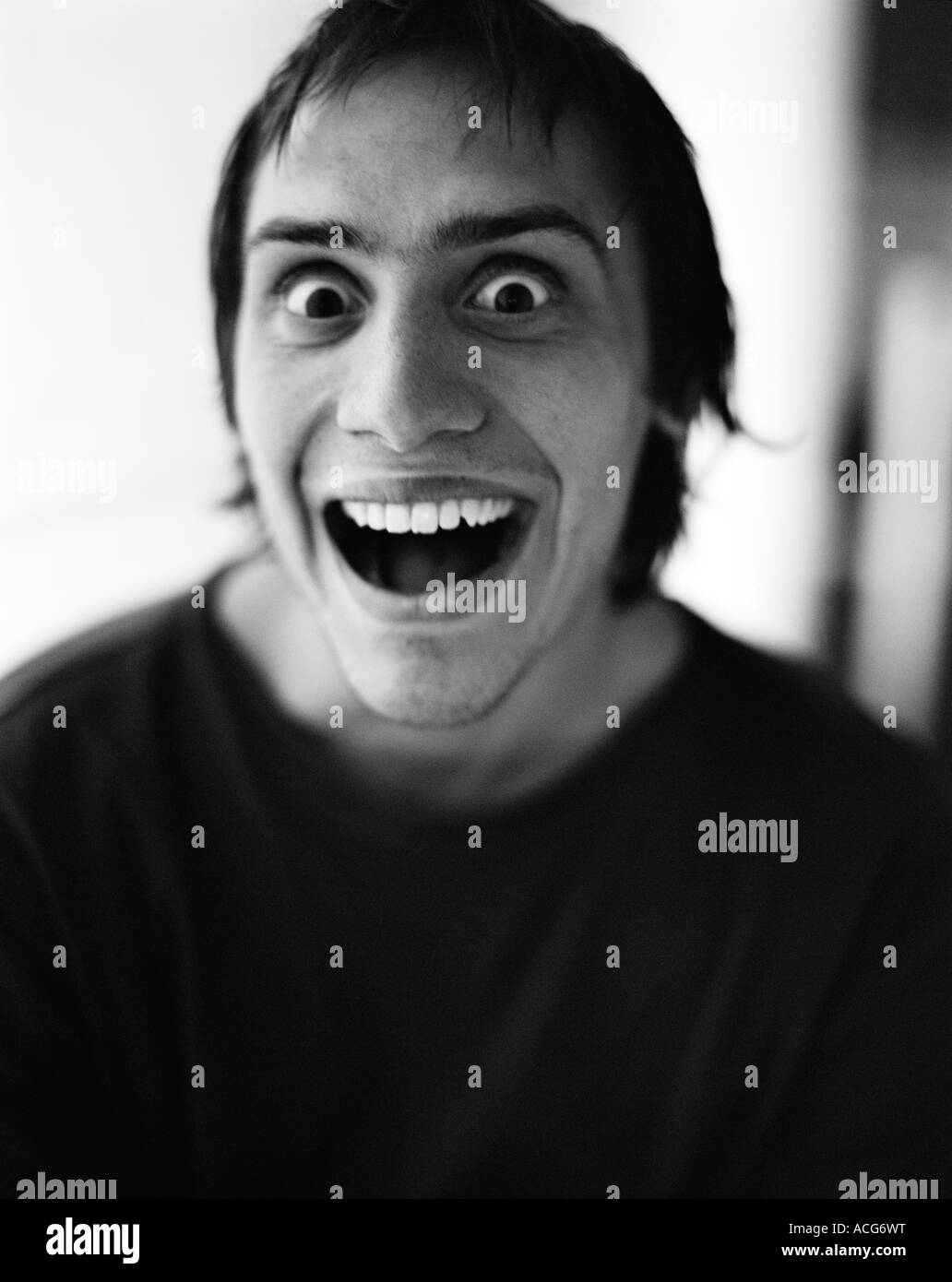 A man with a wild facial expression portrait BW Stock Photo - Alamy