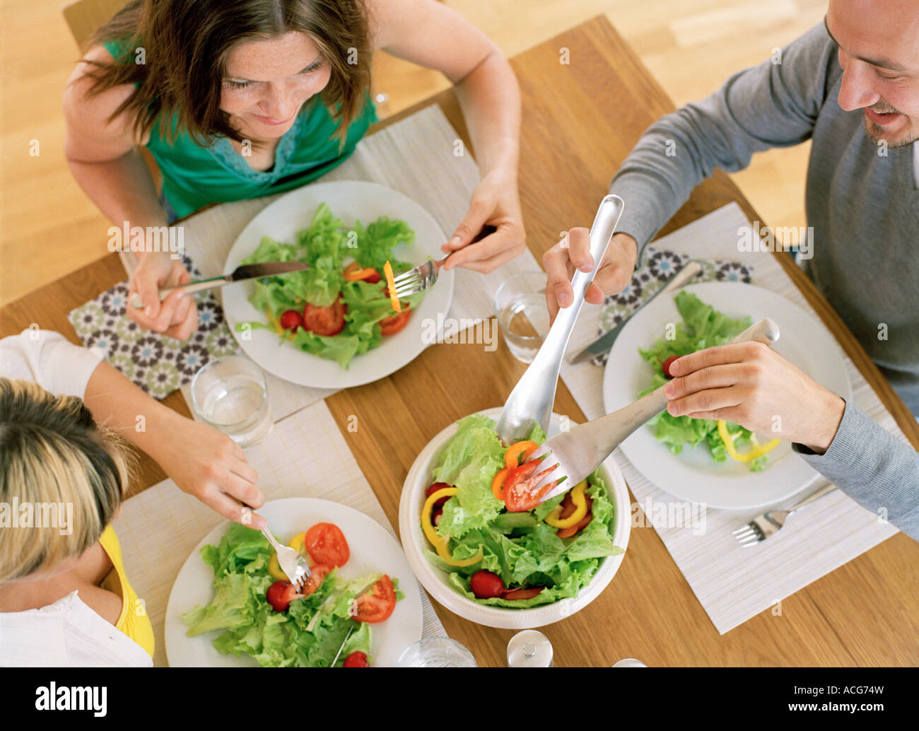 Three people at a dinner table photographed from above Stock Photo - Alamy