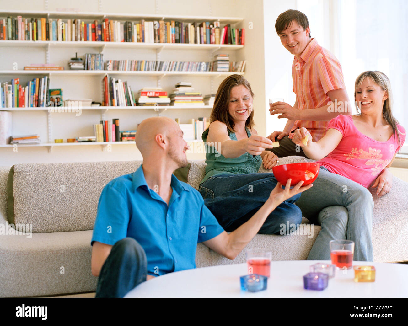 Four people in a living room Stock Photo - Alamy