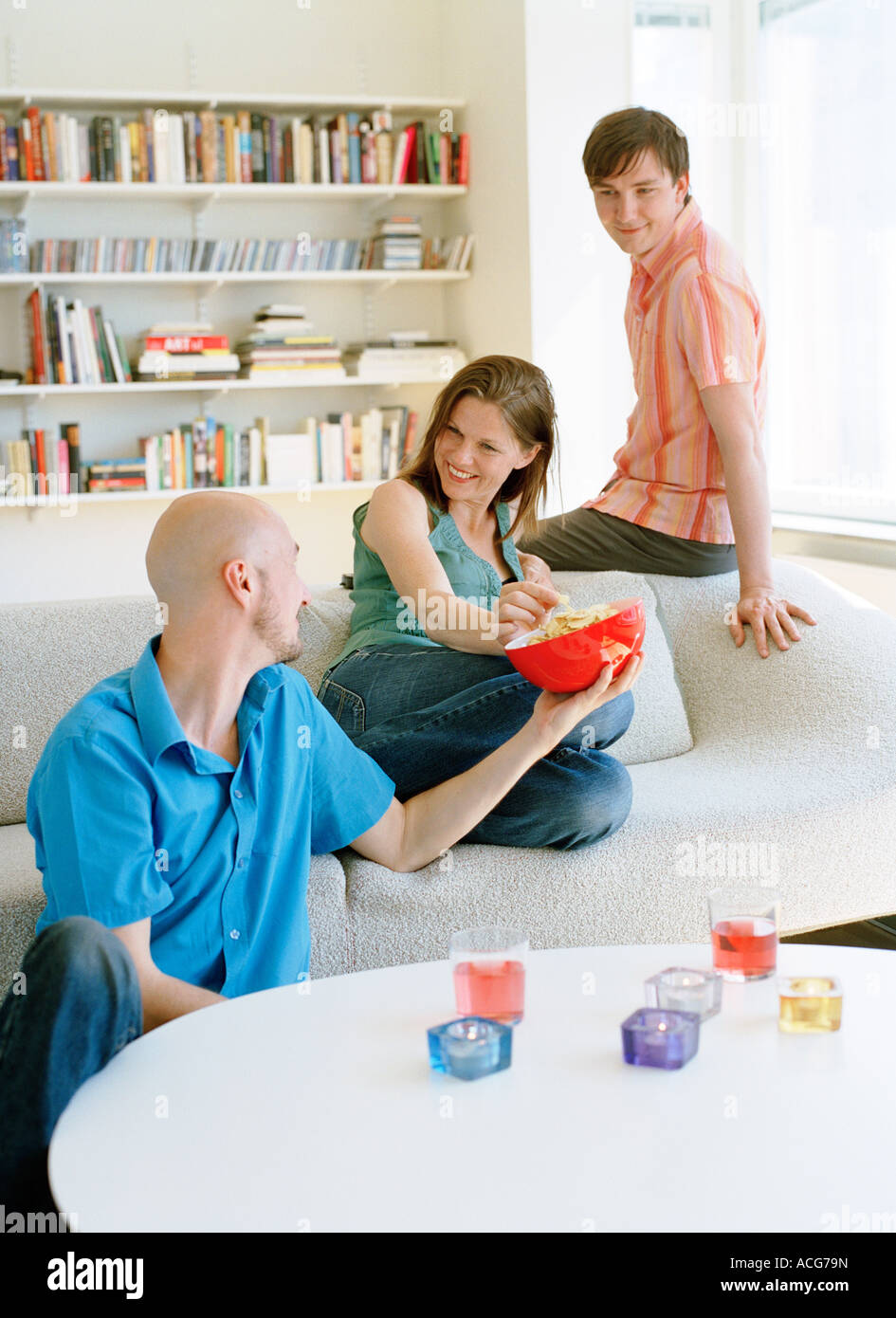 Three people in a living room Stock Photo - Alamy