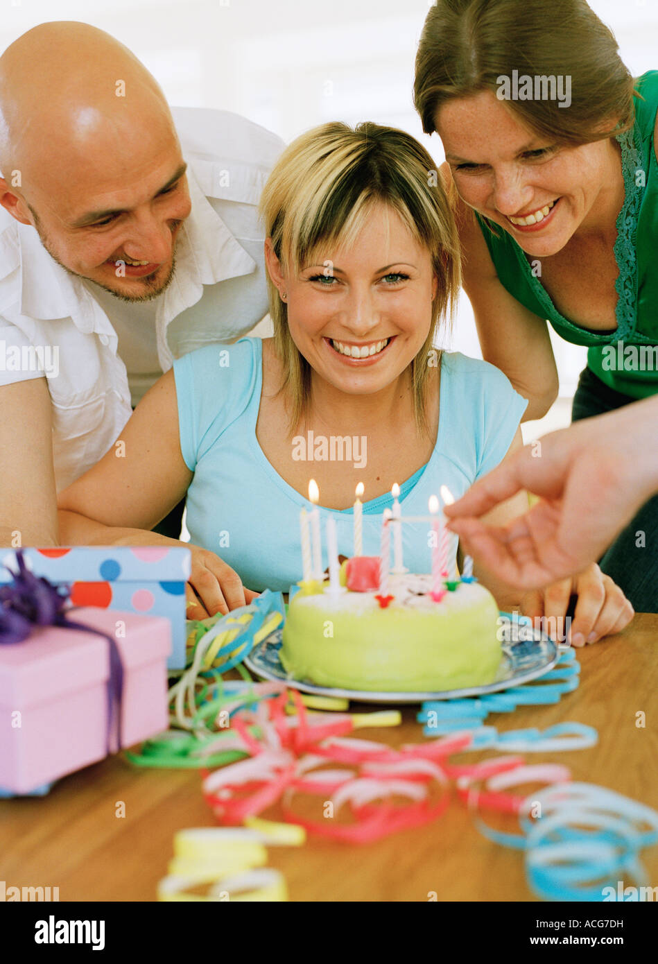 Three people and a birthday cake Stock Photo - Alamy