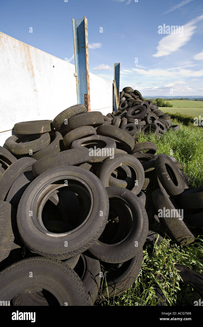 Tyres dumped on farmland Wales UK Stock Photo - Alamy