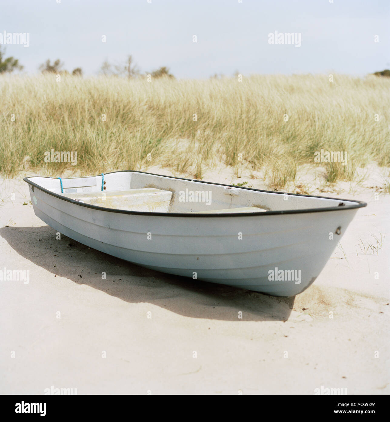 A empty rowing boat on a sandy beach Stock Photo - Alamy