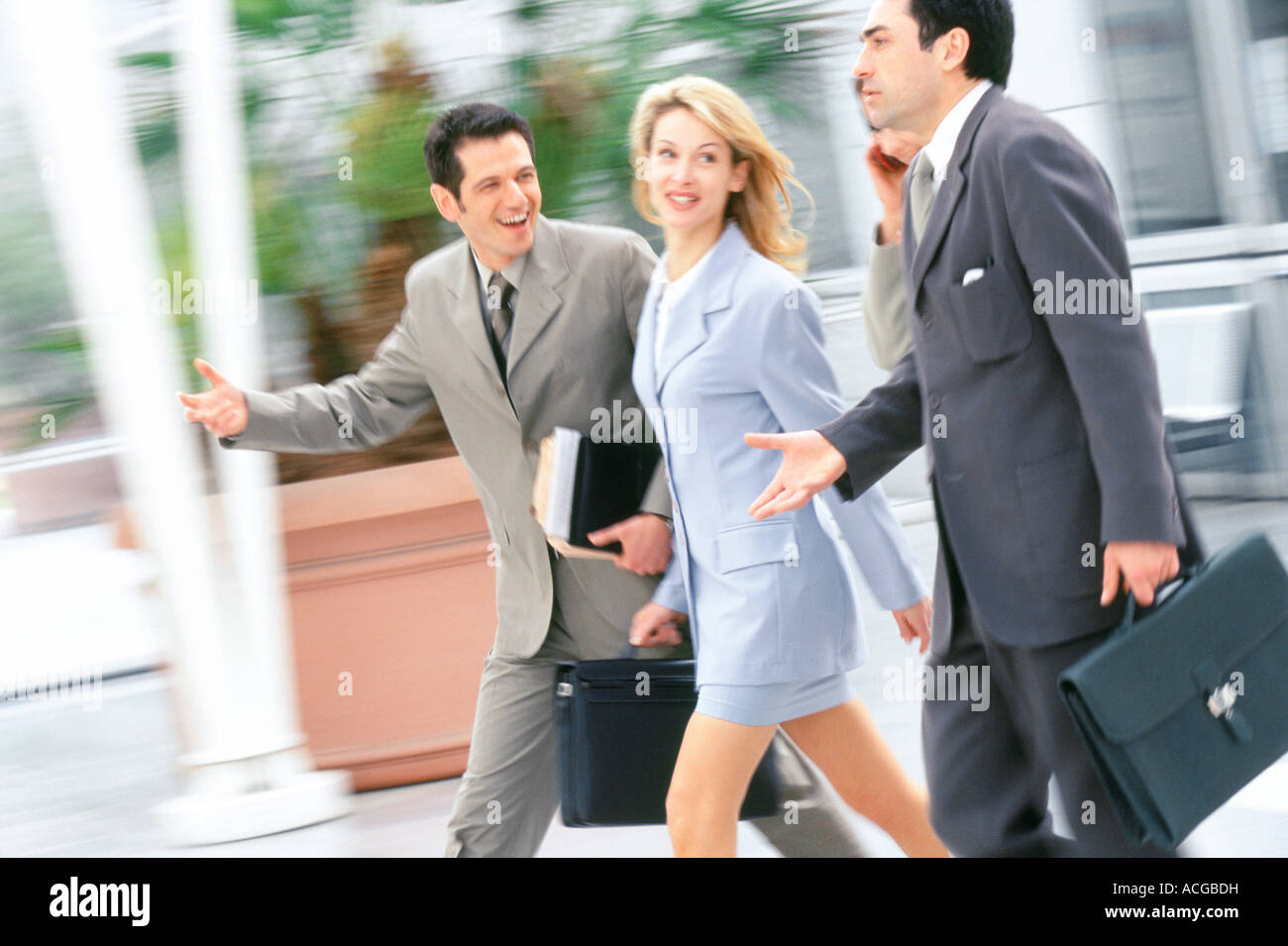 Men and women talking while walking smiling blurred effect Stock Photo ...