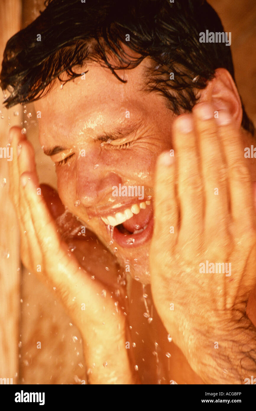Portrait man spraying water on his face Stock Photo - Alamy