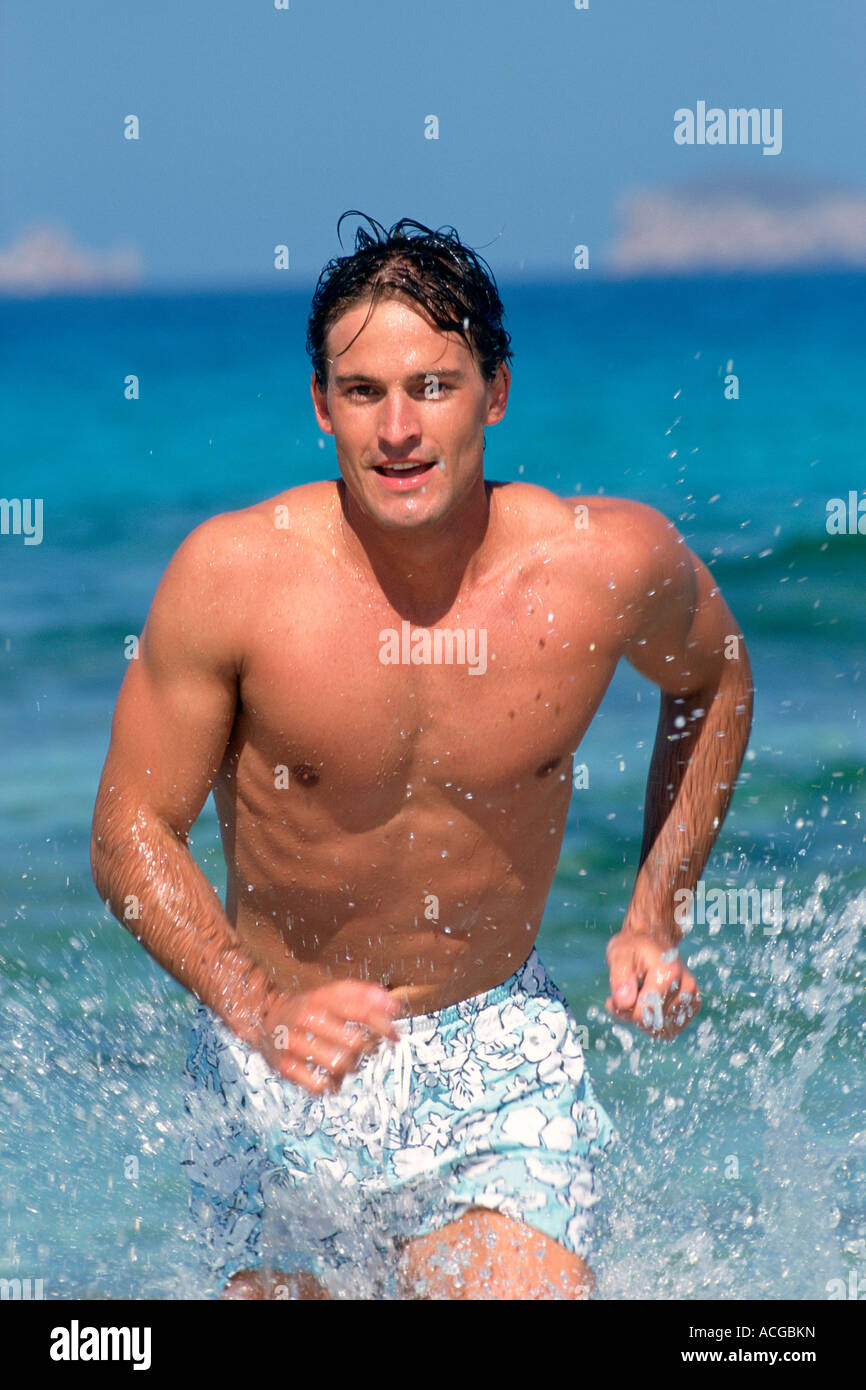 Man running out of the water Stock Photo - Alamy