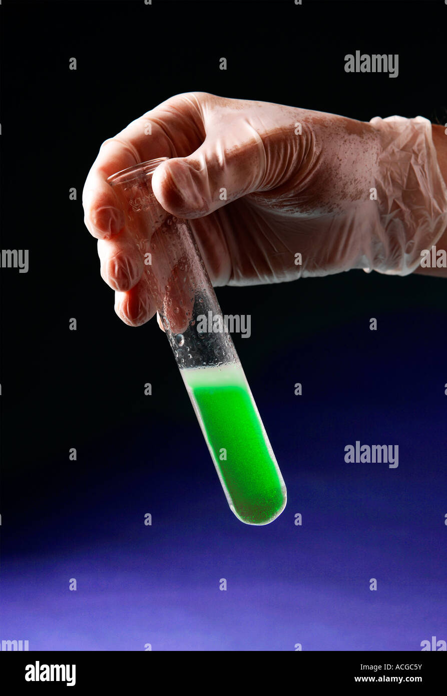 Test tube green in hand Stock Photo - Alamy