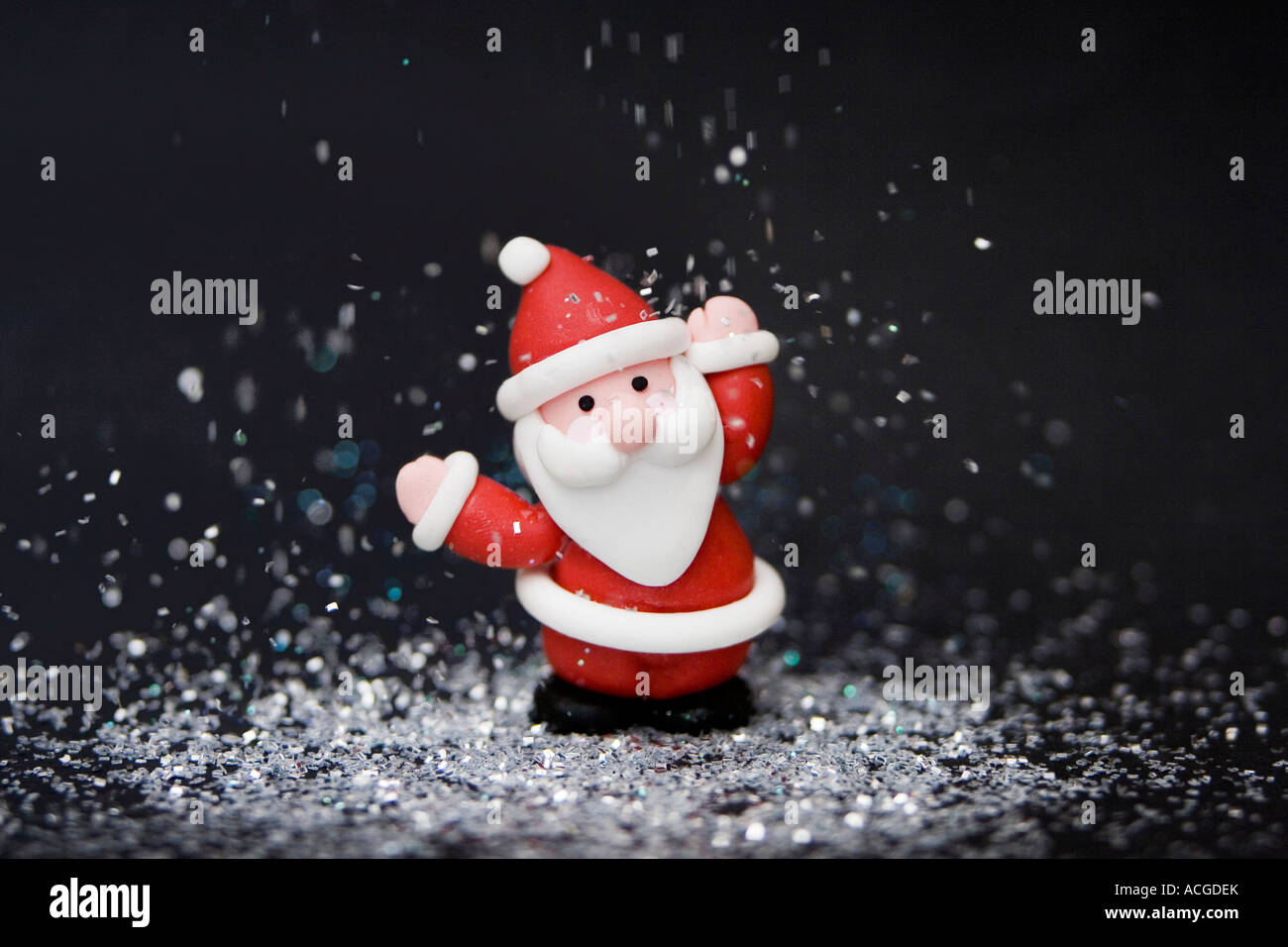 Father Christmas decoration against black surrounded by glitter Stock ...