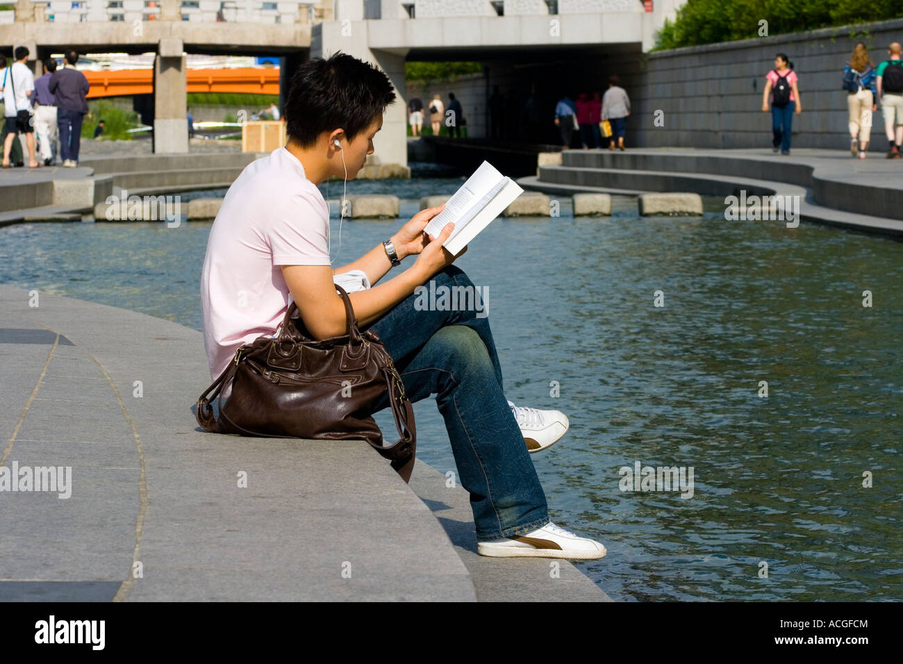 Young Korean Man Reading on Cheonggyecheon or Cheonggye Stream Seoul ...