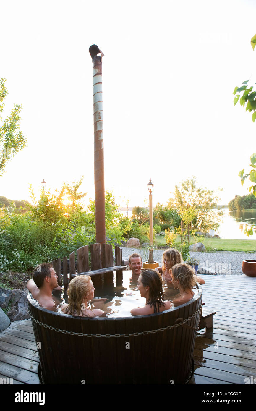 A group of people bathing in a barrel outdoors Stock Photo - Alamy