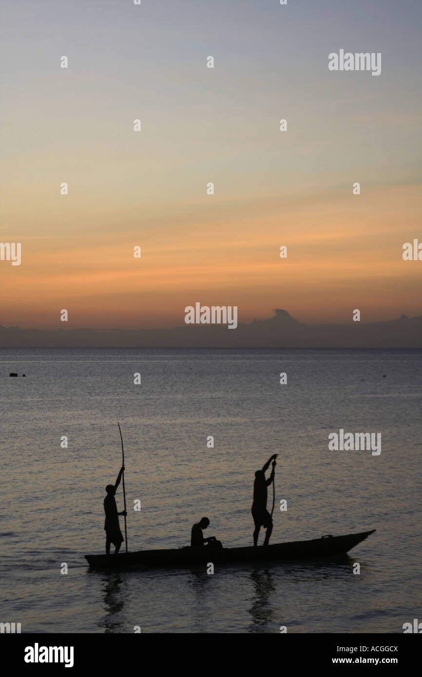 Silhouette of fishermen at Ras Nungwi beach at sunset on Zanzibar in ...