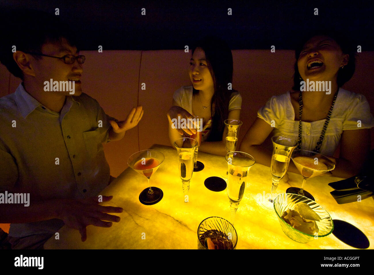 Young Asian Women and Man Socializing at Felix Bar Peninsula Hotel ...